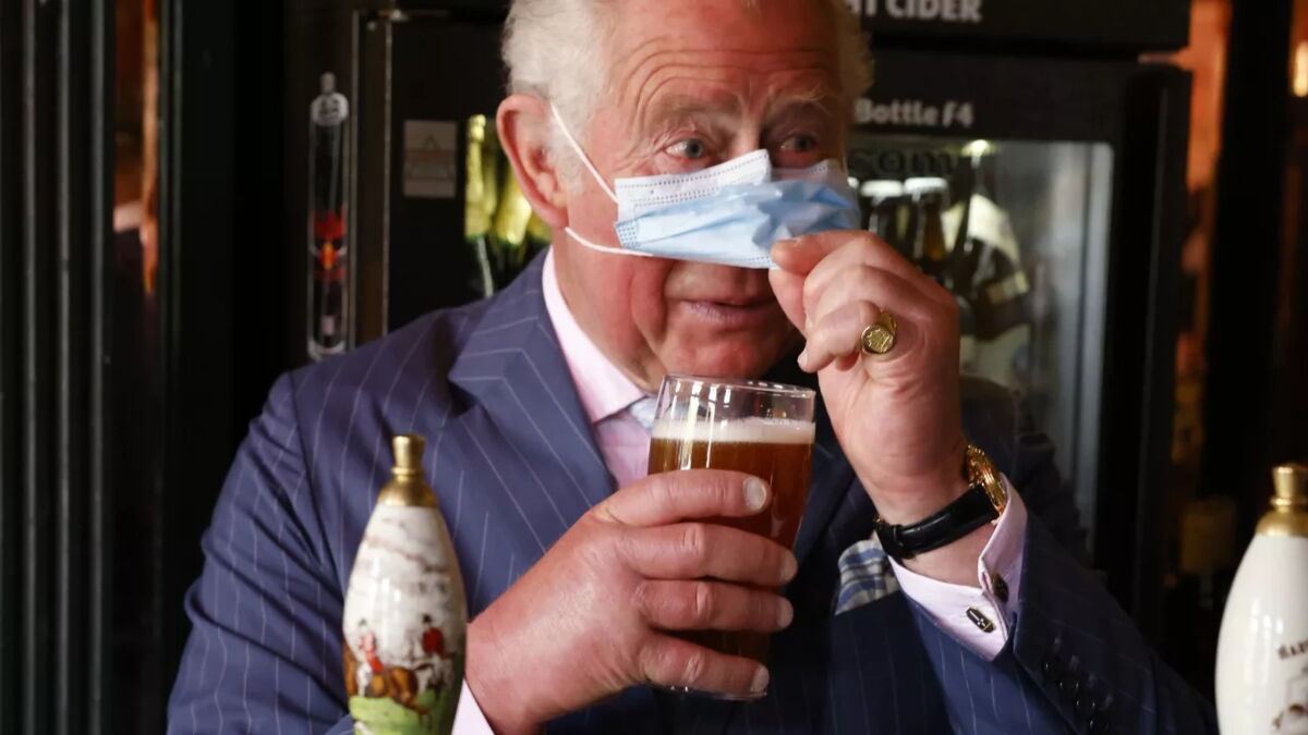Prince Charles takes a sneaky sip of beer while visiting local businesses